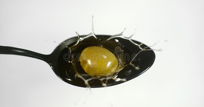 Green Olive, Olea Europaea, Falling in a Spoon Against White Background ...