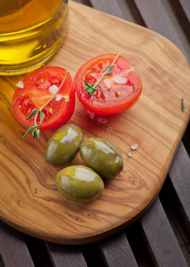 Green olives and tomatoes stock image. Image of food - 24326099
