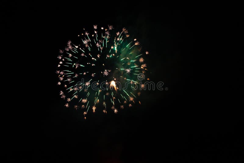 Green and Orange Dragon`s Eggs Firework Exploding in the Sky Stock ...