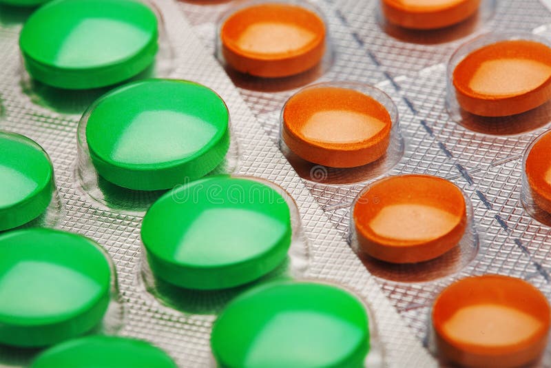 Red and Orange, Green Pills in a Silver Plastic Packaging Stock Image ...