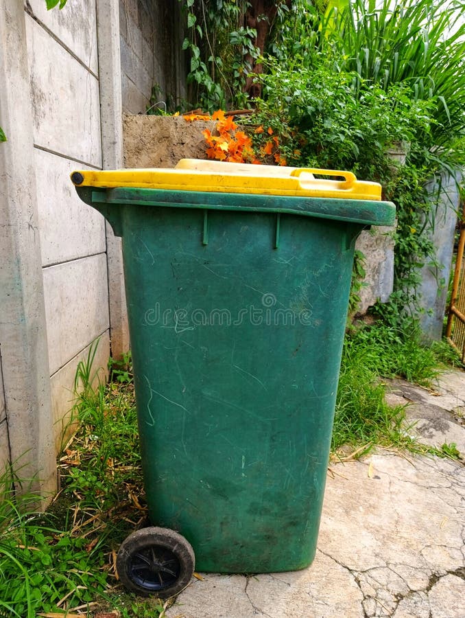 Green outdoor trash can stock image. Image of street - 385371351