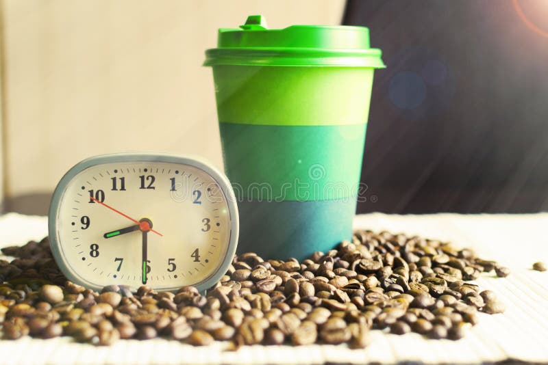 A Green Paper Cup of Coffee with Coffee Beans and an Alarm Clock. Stock ...