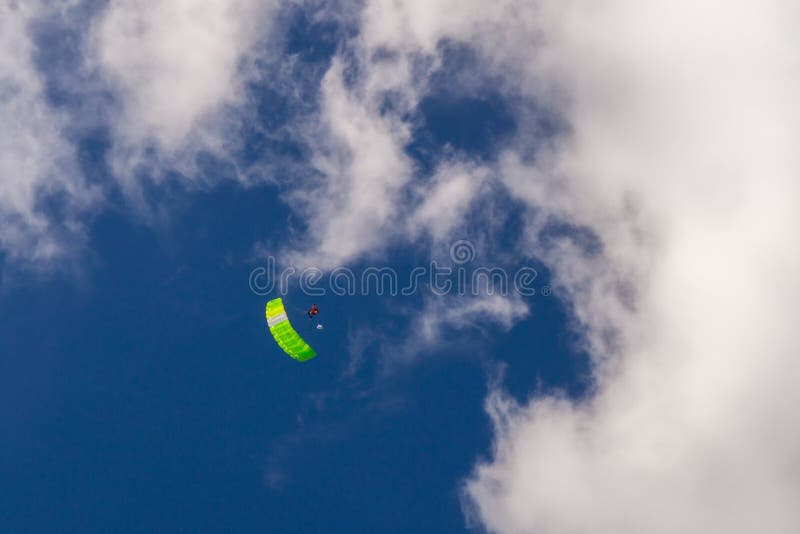 Green Parachute Against the Background of Blue Sky and Clouds Stock ...