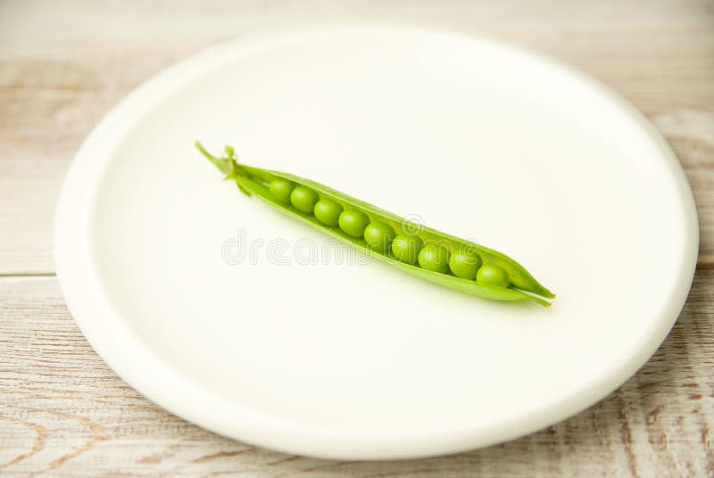 Green Pea Pod on the White Plate. Stock Photo - Image of open ...