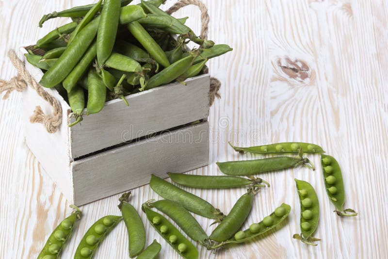 Green peas in a wooden box stock photo. Image of organic - 72291684