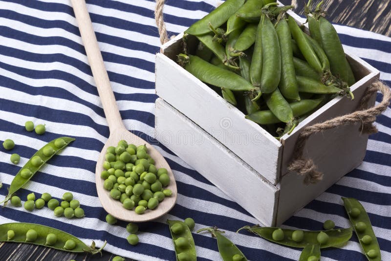 Green peas in a wooden box stock photo. Image of peas - 73103952