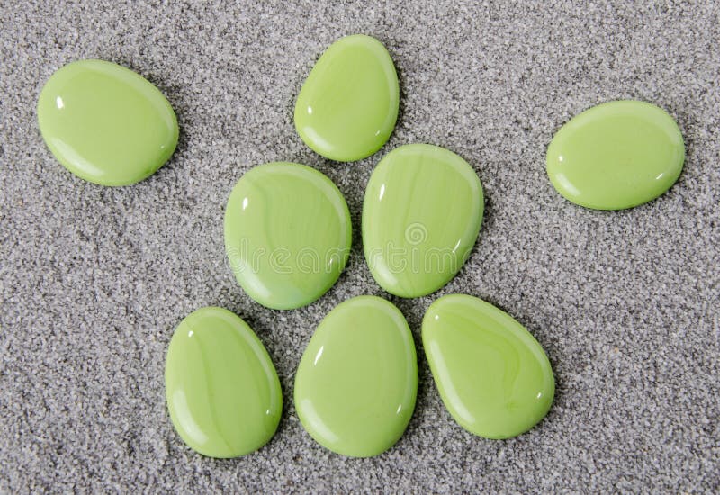 Green pebbles on the sand stock photo. Image of life - 41139090
