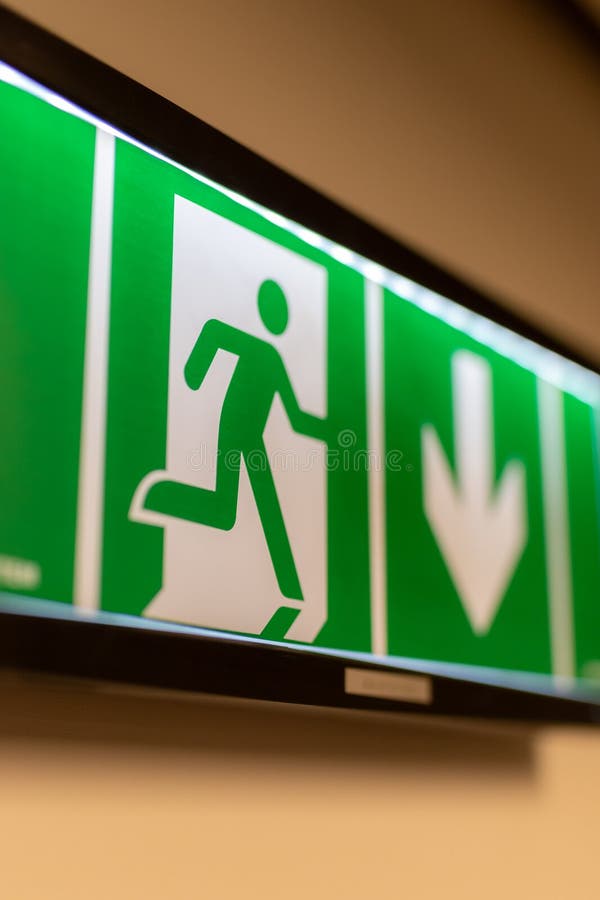 Green Person Exit Sign. Evacuation Sign. Emergency Exit Sign. Bokeh ...