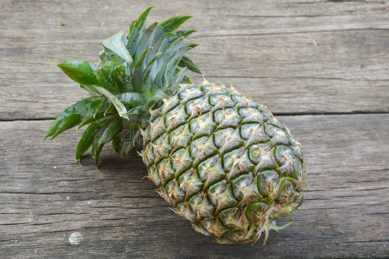 Green Pineapple on Wood Plank Stock Image - Image of leaves, sweet ...