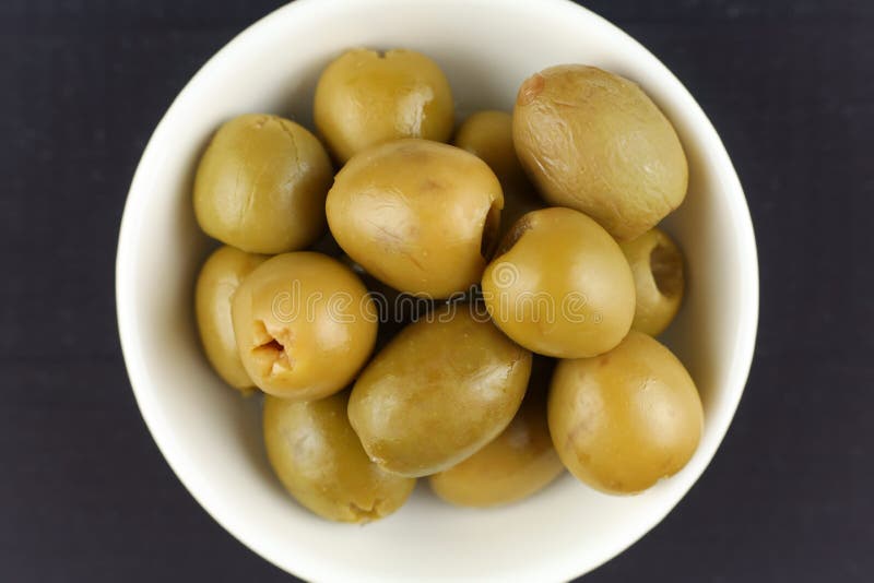 Green Pitted Olives in a White Plate. Olives Close-up Top View Stock ...