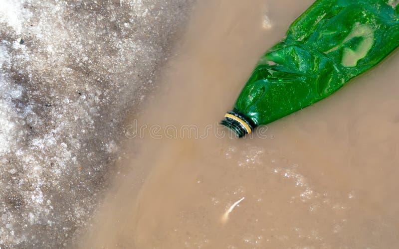 Green Plastic Bottle in an Icy Puddle Stock Image - Image of lake ...