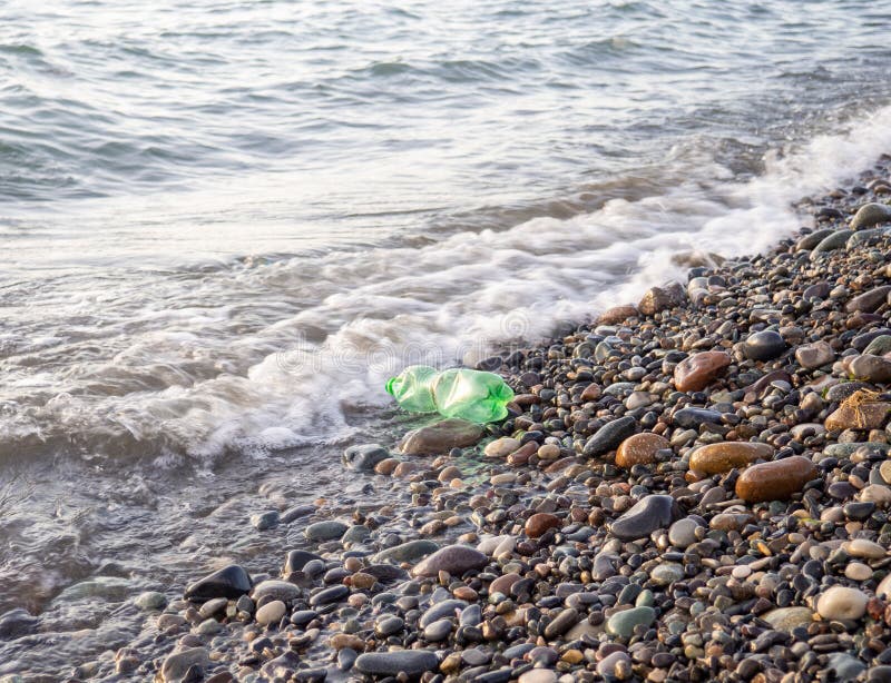 A Green Plastic Bottle Washed Ashore. . Plastic Container on the Beach ...