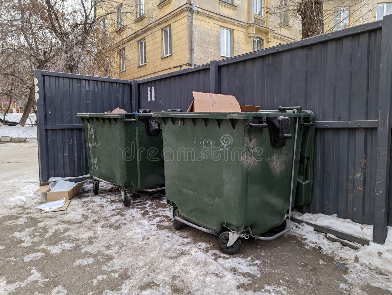 Green Plastic Containers for Garbage Collection in the Yard of an Old ...