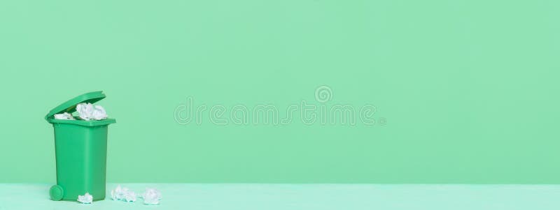 A Green Plastic Garbage Bin and Paper on Green Background, Great for ...