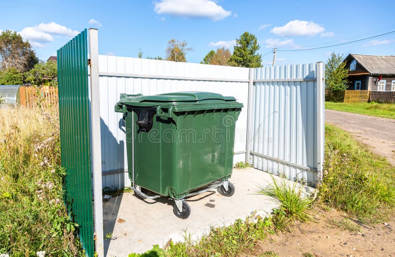 Green Plastic Garbage Container at the Outdoors in Village in Summer ...