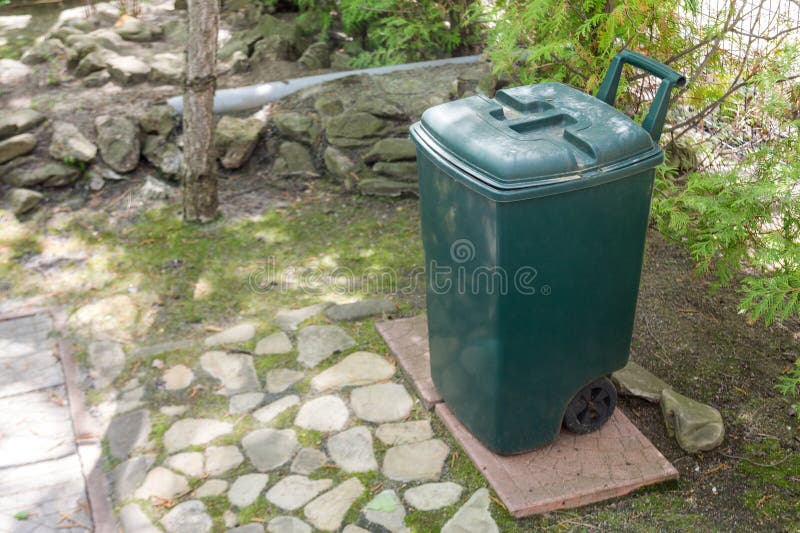Green Plastic Garbge Bin in Garden.Single Garbage Container Stand in ...