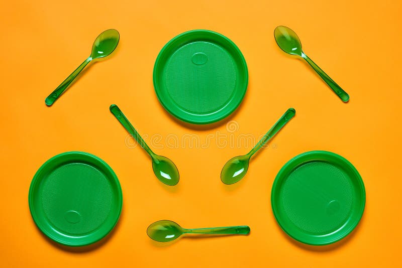 Green Plastic Spoons and Plates Stock Photo - Image of orange, table ...