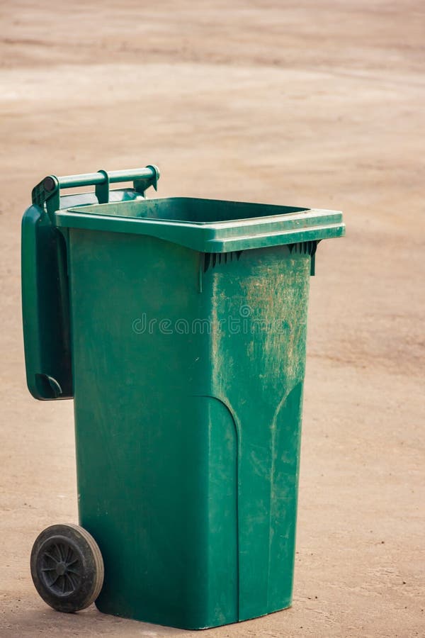 Green Plastic Trash Container on Wheels Stands on the Ground. Ab Stock ...