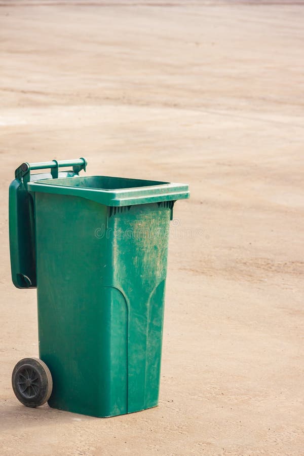 Green Plastic Trash Container on Wheels Stands on the Ground. Ab Stock ...