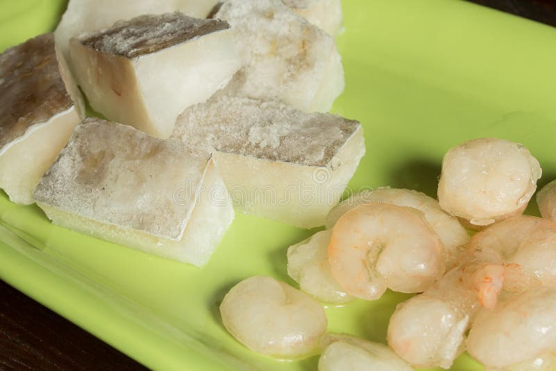 Green Platter with Thawed Cod Fillets and Prawns. Stock Image - Image ...