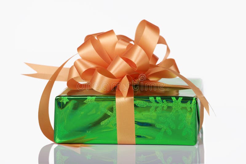 Green Present with Red Ribbon Over Snow Stock Photo - Image of modern ...