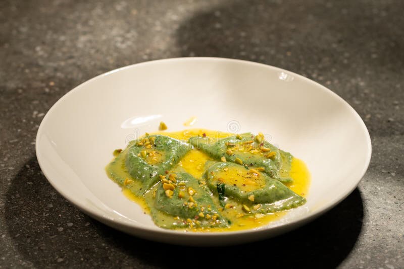 Green Ravioli with Spinach and Nuts in a Plate Stock Photo - Image of ...