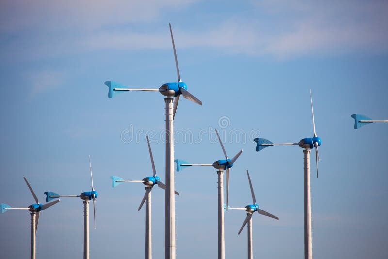 Green Renewable Energy Concept - Wind Generator Turbines on Blue Stock ...
