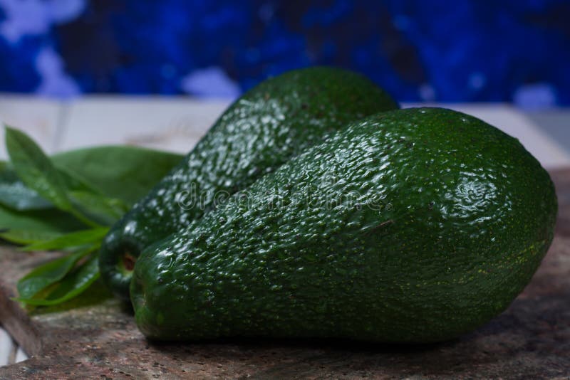 Green Ripe Avocado with Leaves on Granite Plank Stock Image - Image of ...