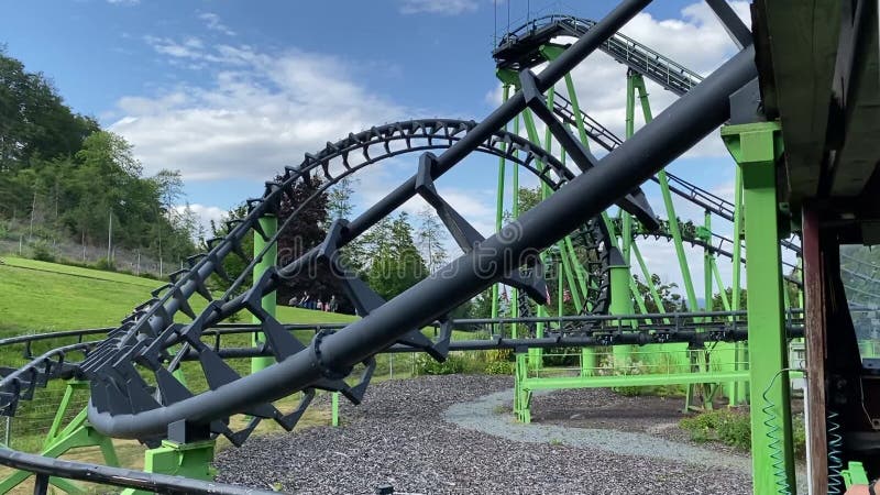 Green Roller Coaster in an Amusement Park Stock Video - Video of ...