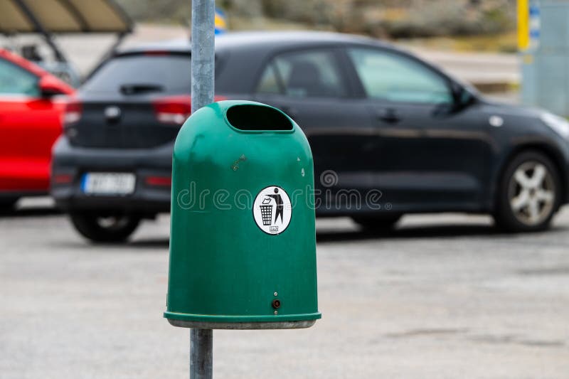 Green Round Plastic Trash Can by a Parking Lot.. Stock Photo - Image of ...