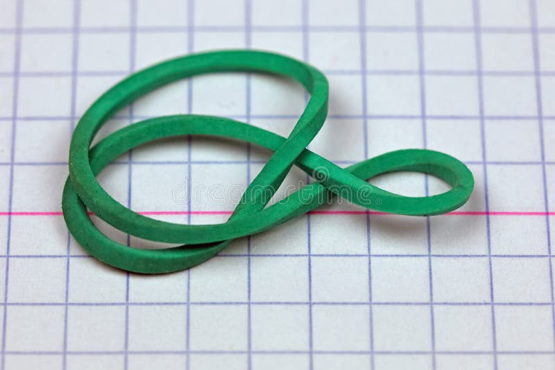Green Rubber Band on a Sheet of Paper Stock Image - Image of chequered ...