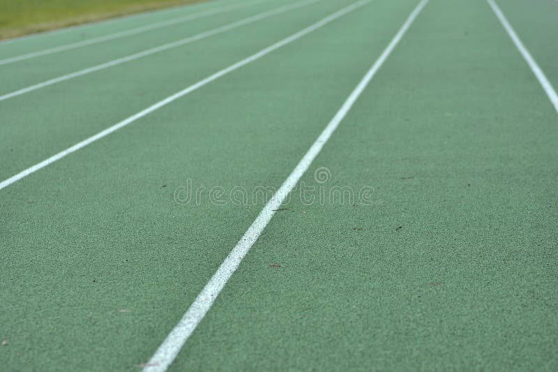 Green Running Track with White Lines and Green Grass Stock Photo ...