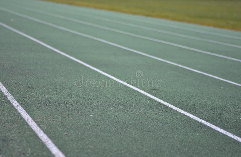 Green Running Track with White Lines and Green Grass Stock Photo ...