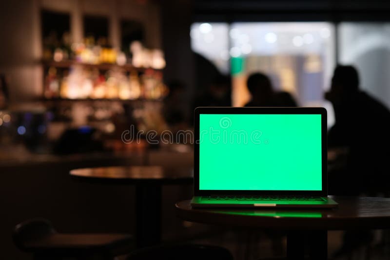Green Screen Laptop Computer on Bar Table at Night Stock Photo - Image ...