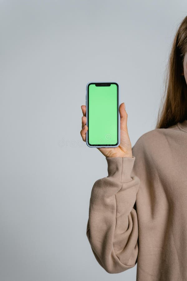 Woman Holding Phone in Hand with Green Screen Stock Photo - Image of ...