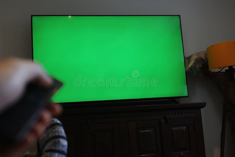 Green Screen Tv. Man Holding Remote Control Turning on Tv Changing ...