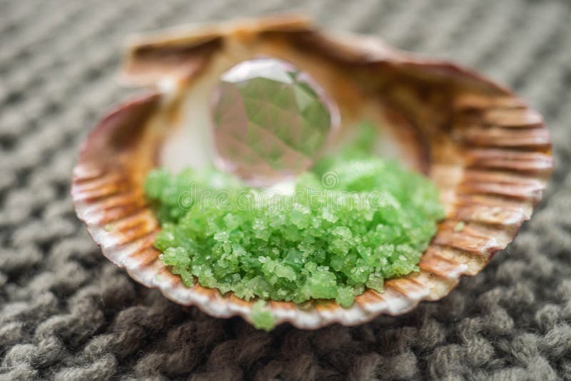 Green Sea Salt and Pink Crystal in a Seashell on a Gray Knitted Surface ...