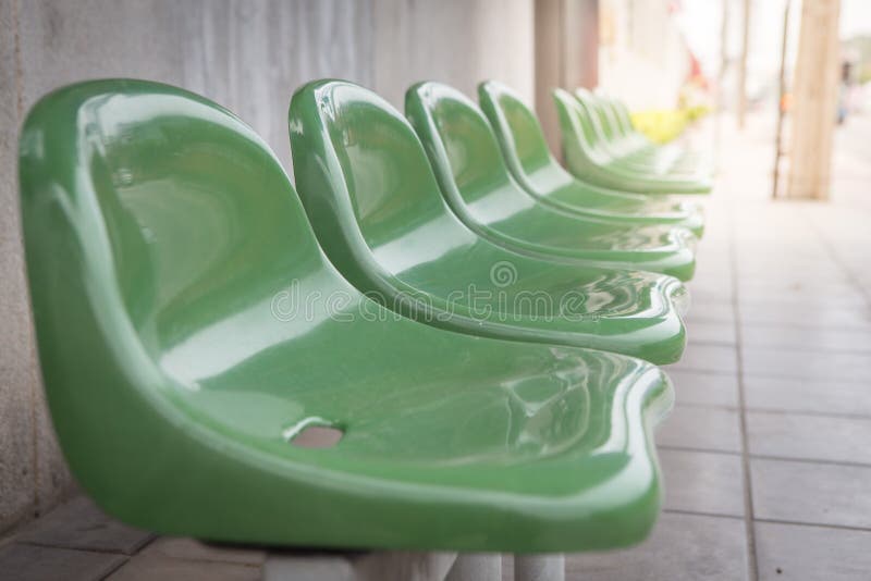 Green seat in the bus stop stock photo. Image of cars - 135757766