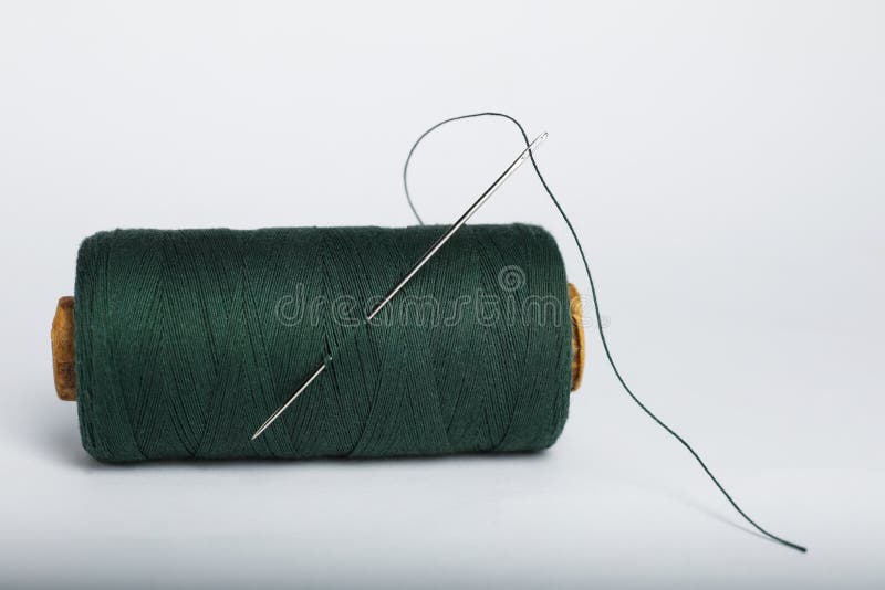 Green Sewing Thread with Needle on White Background Stock Photo - Image ...