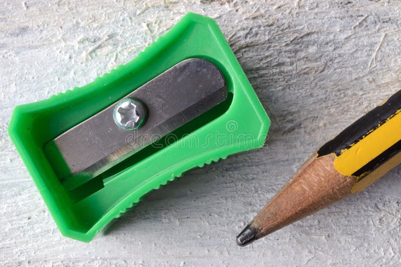 A Green Sharpener and a Pencil on a White Table. Stock Photo - Image of ...