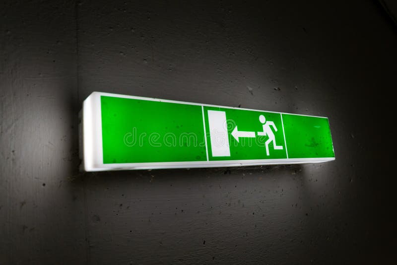 Green Escape Exit Sign on White Concrete Wall Stock Image - Image of ...