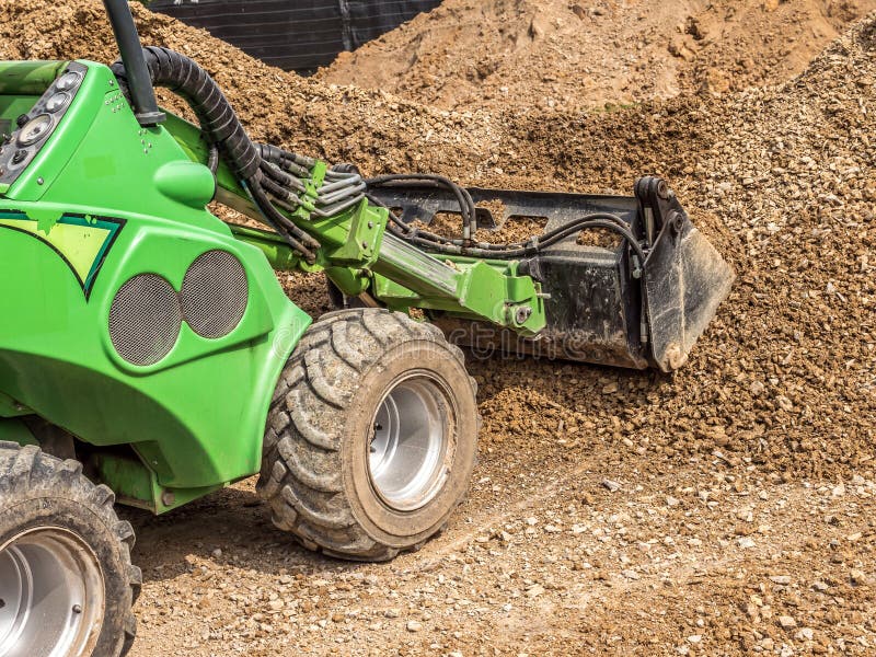 Skid loader at work stock image. Image of loader, digging - 120960555