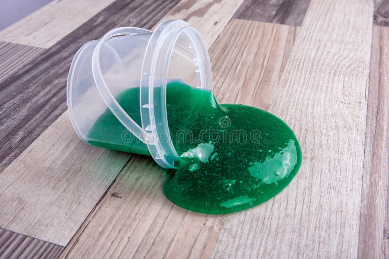 Green Slime Toy Flowing Out from a Plastic Bucket Stock Photo - Image ...