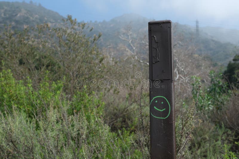 Green Smiley Face on Metal Pole in Hillside Stock Image - Image of grin ...