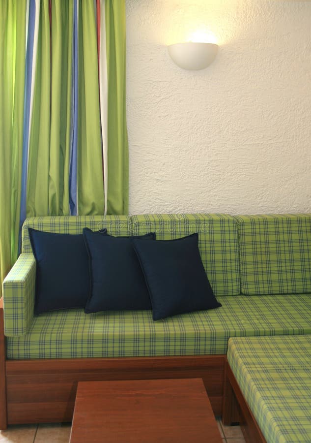 Green sofa and curtain stock image. Image of decorating - 3680041