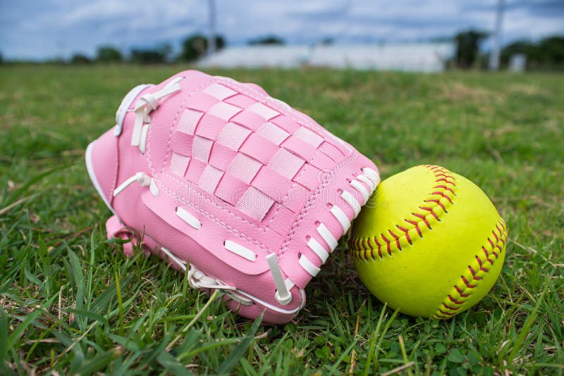 Green Softball and Pink Softball Glove on Field Stock Image - Image of ...