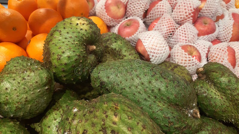 Green, Spiky Soursops, Contrasted with Bright Oranges and Netted Bags ...