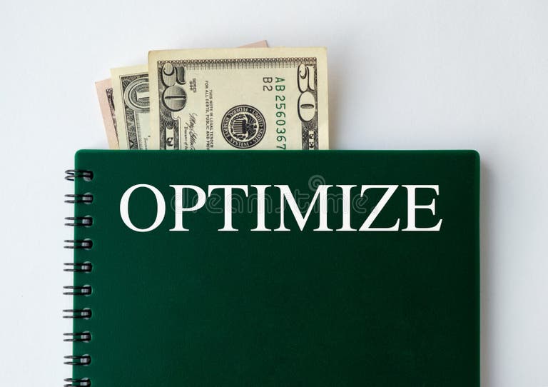 A Green Spiral Notebook with a Stack of Money in the Pocket Stock Photo ...