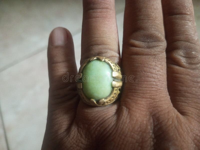 A Green Stone Ring Circular on His Finger Stock Photo - Image of finger ...
