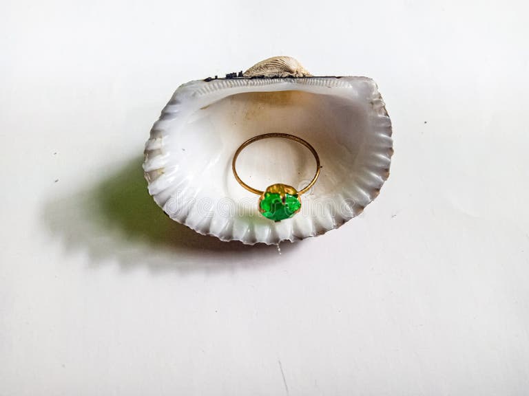 A Green Stone Ring Inside a Shell Stock Photo - Image of object ...